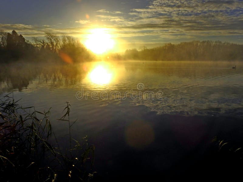 The Rising Sun Reflecting Off the Lake`s Surface Stock Image - Image of ...