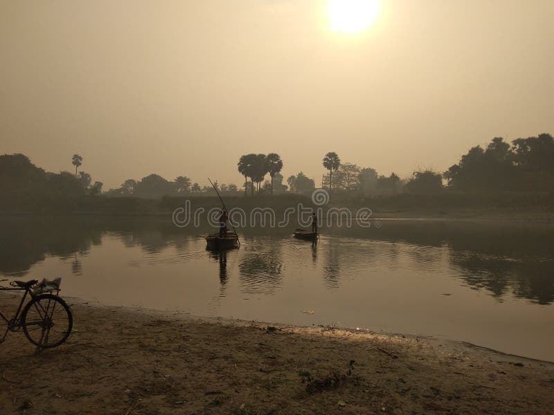 Rising sun stock photo. Image of river, yellow, boats - 130837134