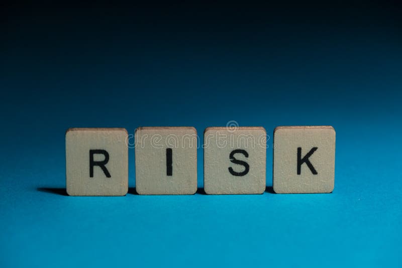 Risk: Square Wooden Letters on a Blue Background Stock Photo - Image of ...