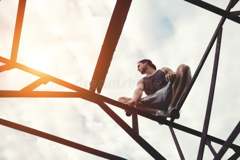 Risky Brave Man Balancing and Sitting on High Metal Construction Stock ...