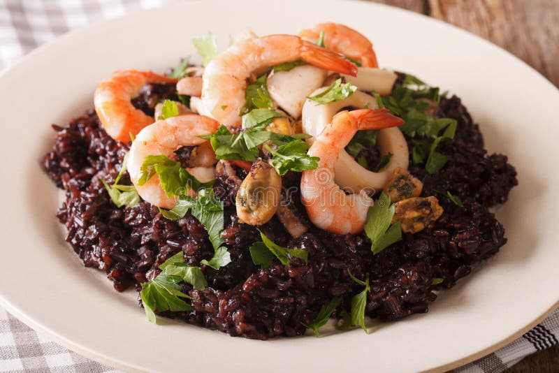 Risotto of Black Rice with Seafood Close Up on a Plate. Horizontal ...