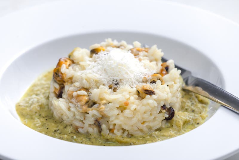 Risotto with Mussels, Sauce and Parmesan Cheese Stock Photo - Image of ...