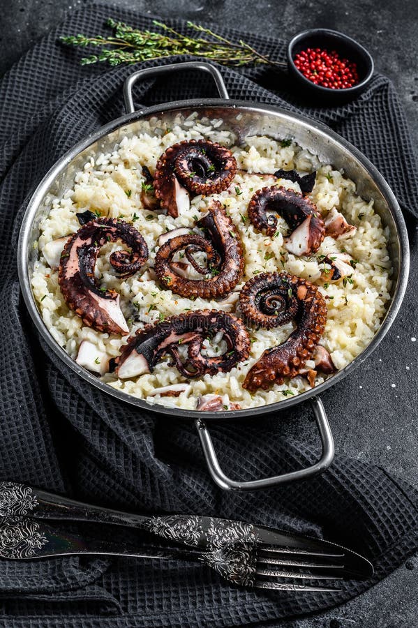 Risotto with Octopus Tentacles in a Pan. Black Background Stock Image ...