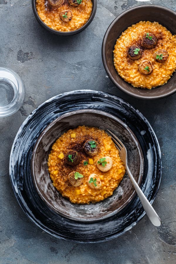 Risotto with Scallops in Black Plates, Top View, Copy Space Stock Photo ...