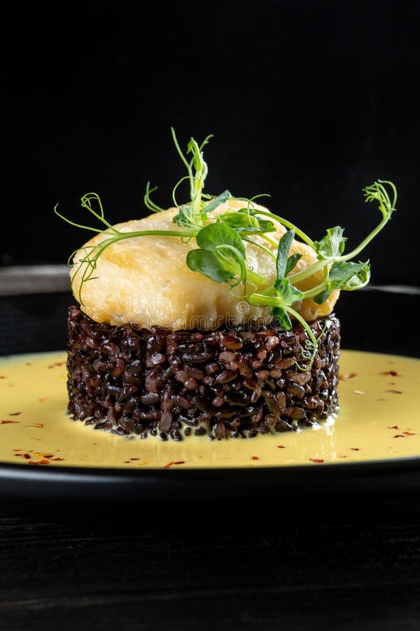 Risotto with Slice Roasted White Fish, Cod on Black Background. Grilled ...