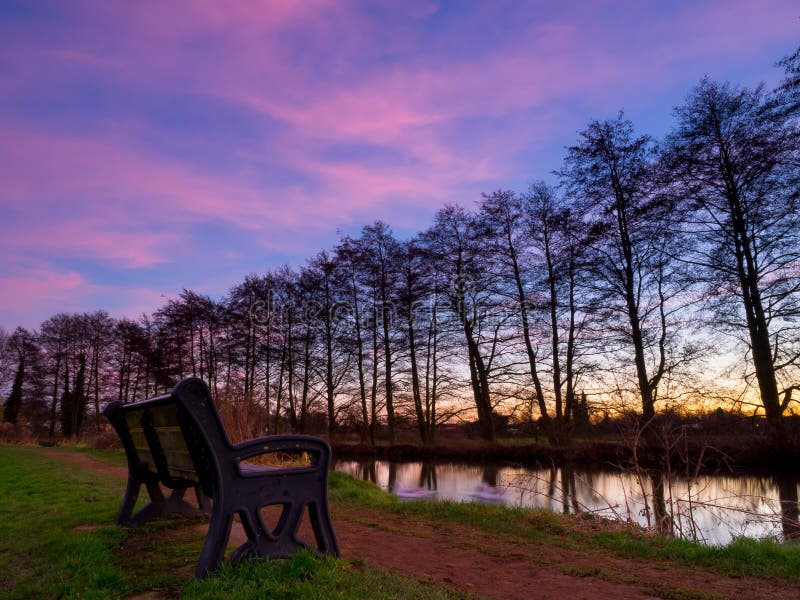 River Bench at Sunset stock photo. Image of tones, blue - 84636630