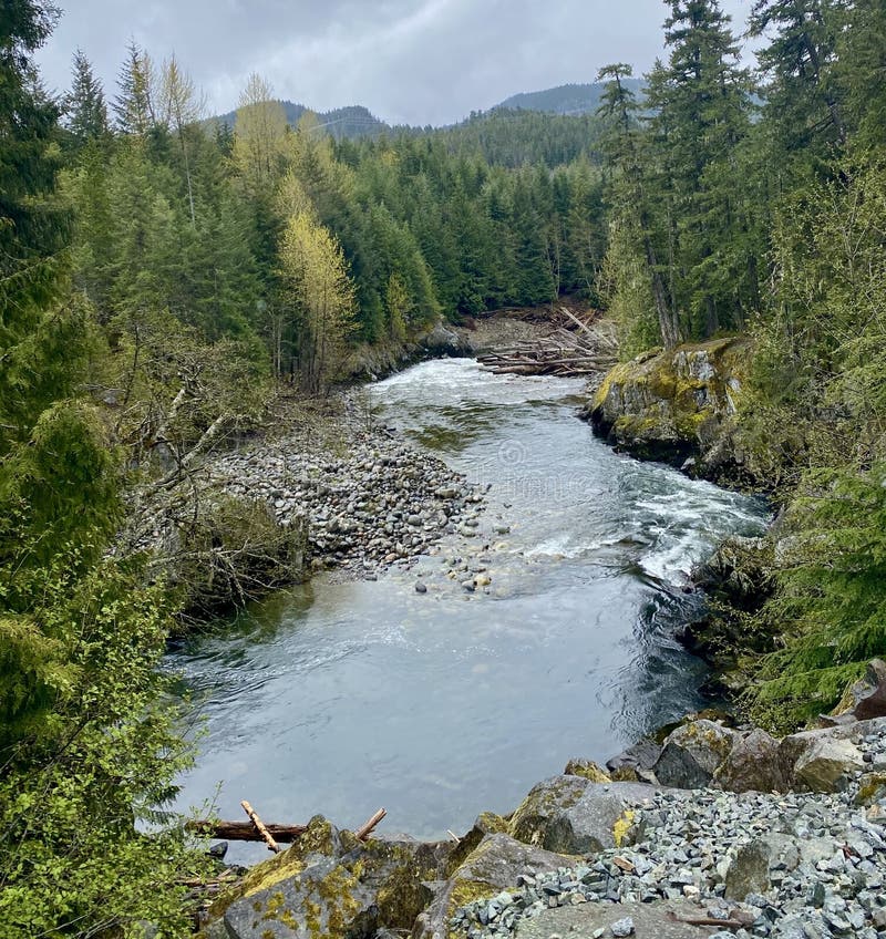 River Bending through Forested Valley with Rocky Shoreline Stock Photo ...
