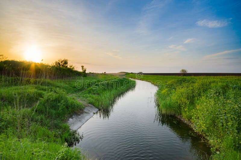 River Canal Running through Meadow Stock Image - Image of growing ...