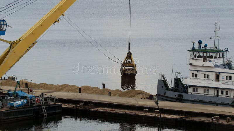 River Cargo Crane - Process of Loading Sand from the Barge To the Ship ...