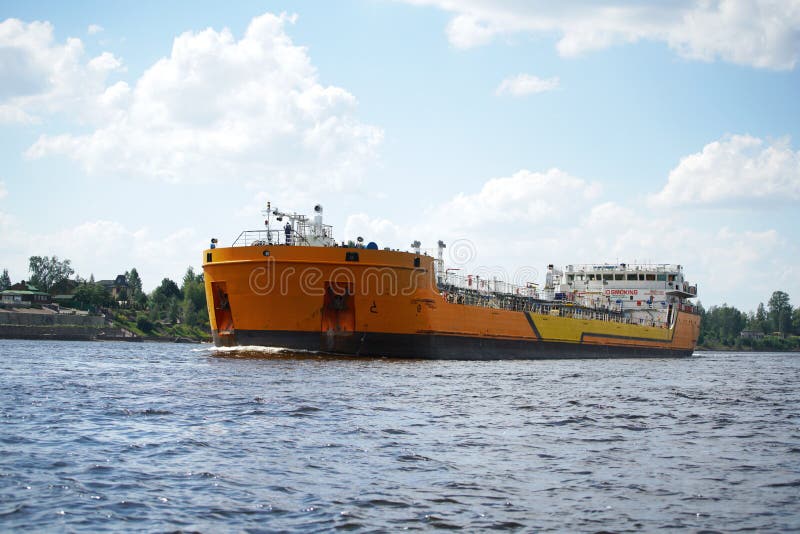 River Cargo Ship Goes Along the River on the Background of Blue Sky ...