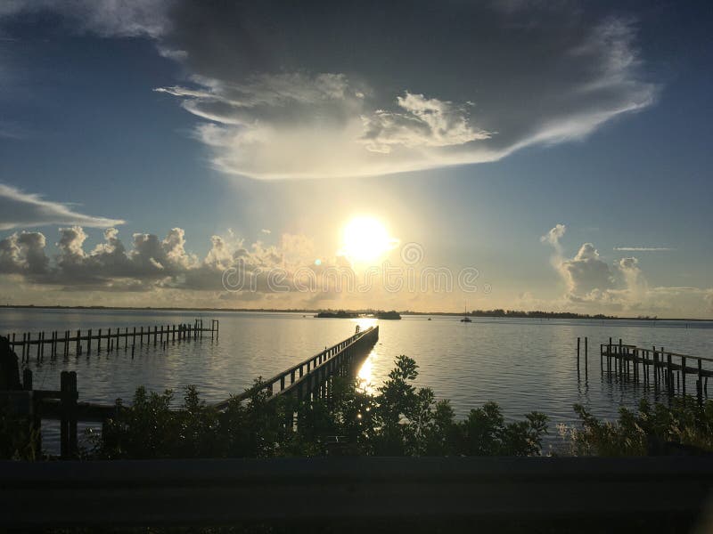 Sunset stock photo. Image of sunset, clouds, dock, water - 248021818