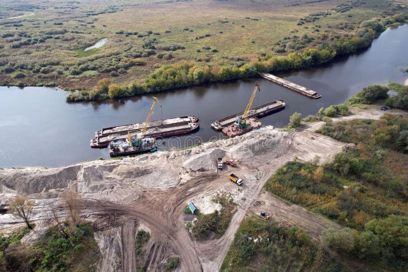 River Excavators are Working on the River, Unloading Sand from Barges ...