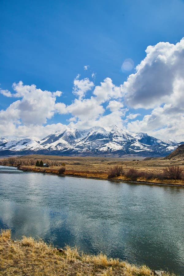 River and Fields with Snowy Mountains and Blue Sky Stock Photo - Image ...