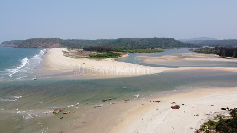 River Flowing into the Ocean with Waves and a Sandy Beach Stock Image ...