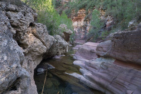 River Flowing through the Red Stone Canyon. Fuentes De Ayodar, Spain ...
