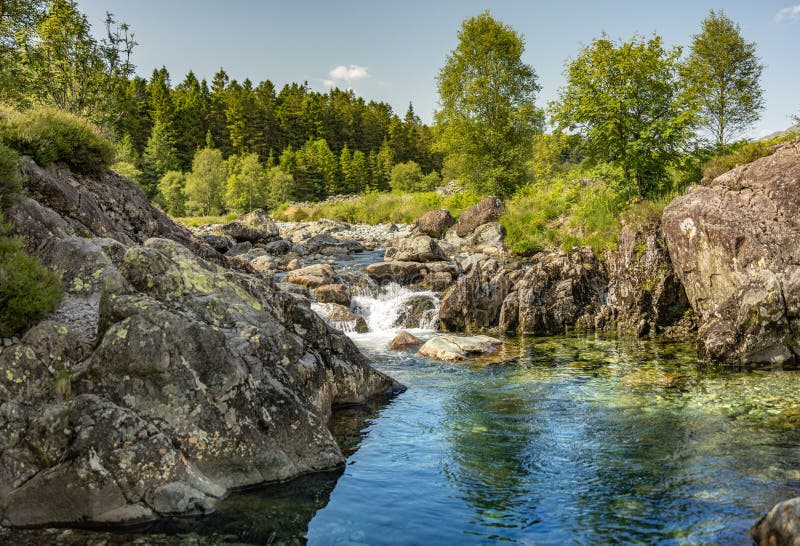 River Flowing between Rocky Cliffs with Green Trees Stock Photo - Image ...