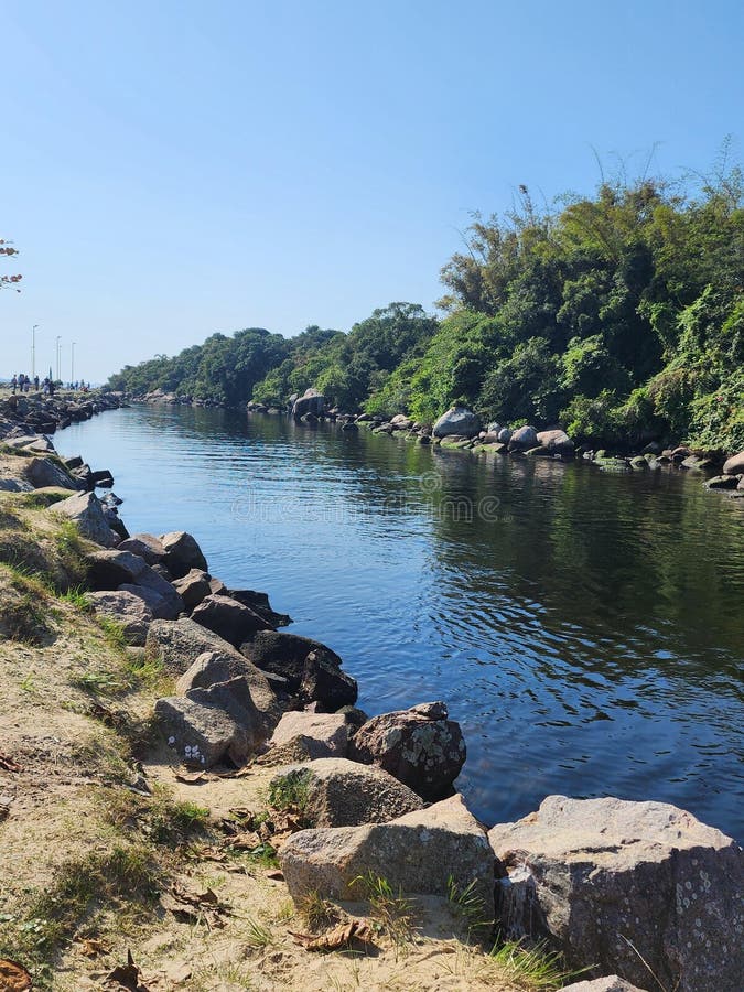 River Flowing into the Sea, with Rocks Around it Stock Image - Image of ...