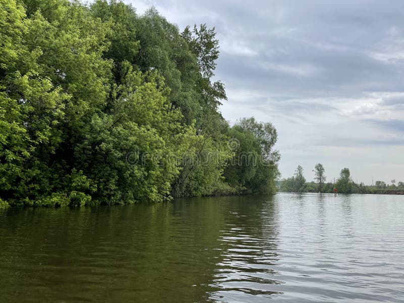 A River Flowing Slowly among the Trees that are Reflected in Its Waters ...