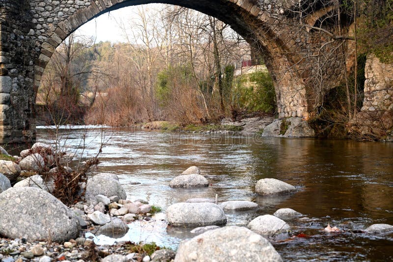 River Flowing Under the Stone Arch Bridge in the Park Stock Photo ...