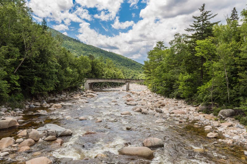 River through Forest Near the White Mountains, a Bridge in Background ...