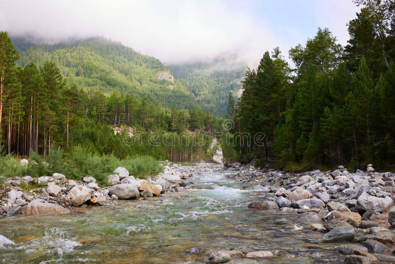 A River with a Rapid Current, Mountain Peaks in the Clouds, a ...