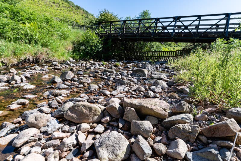 River of Rocks Passing Under Two Different Bridges in Nature. Stock ...