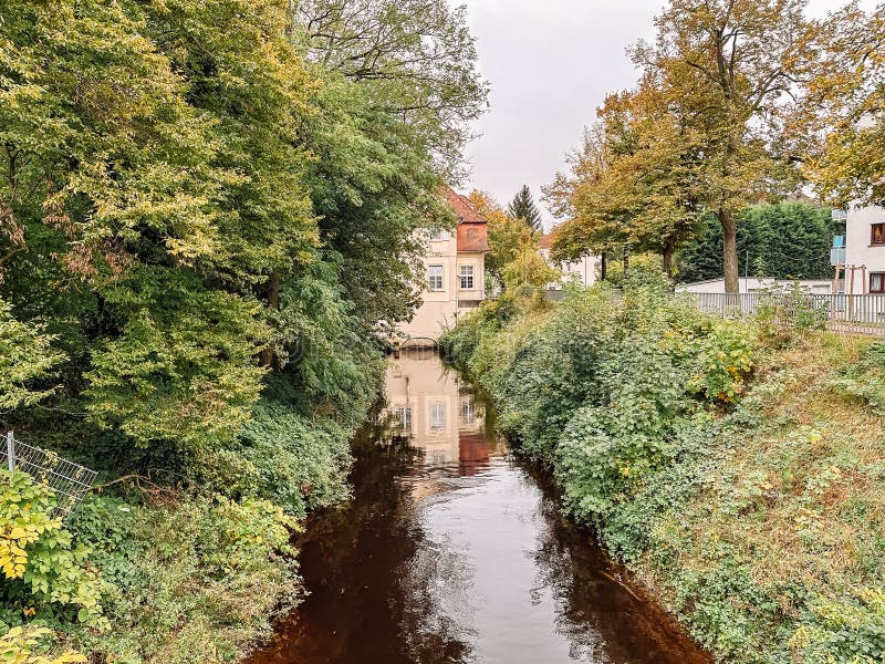 River Runs through a Forest with a House in the Background Stock Image ...