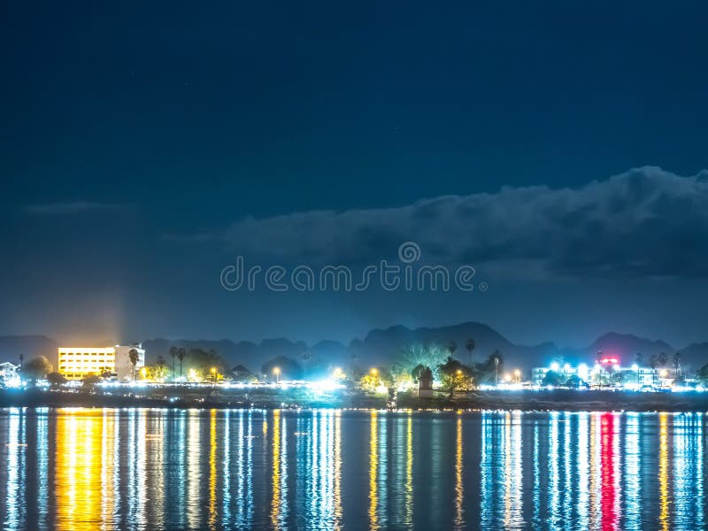 Riverside town at night stock image. Image of colorful - 131122435