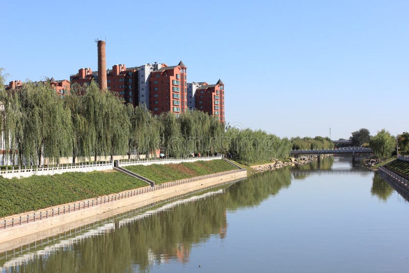A River and Storied Building Stock Photo - Image of town, architecture ...
