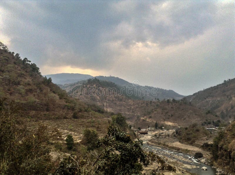 A River Stream Flowing from the Middle of the Hills Stock Photo - Image ...