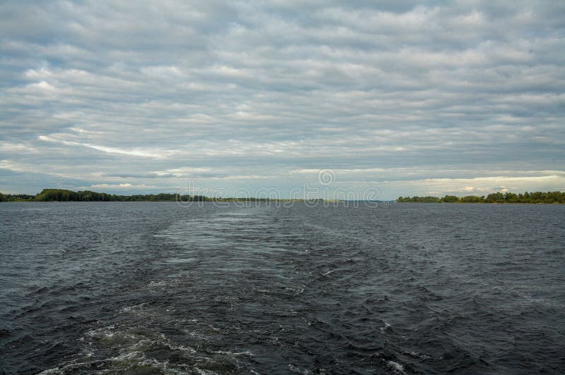River Surface with Wake and Background with the Coast, Forests and ...