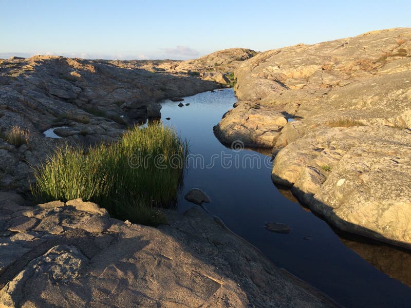 River surrounded by rocks stock photo. Image of reflection - 76059824