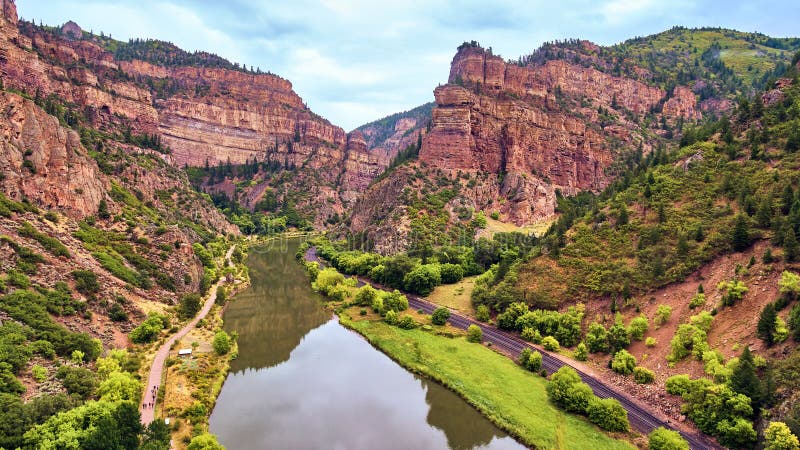 River and Train Tracks through Valley in Red Rock Mountains Stock Photo ...