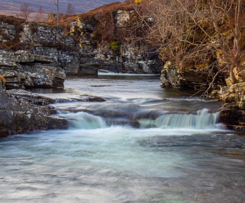 A River with Water Running Over the Side of it and Surrounded by Trees ...