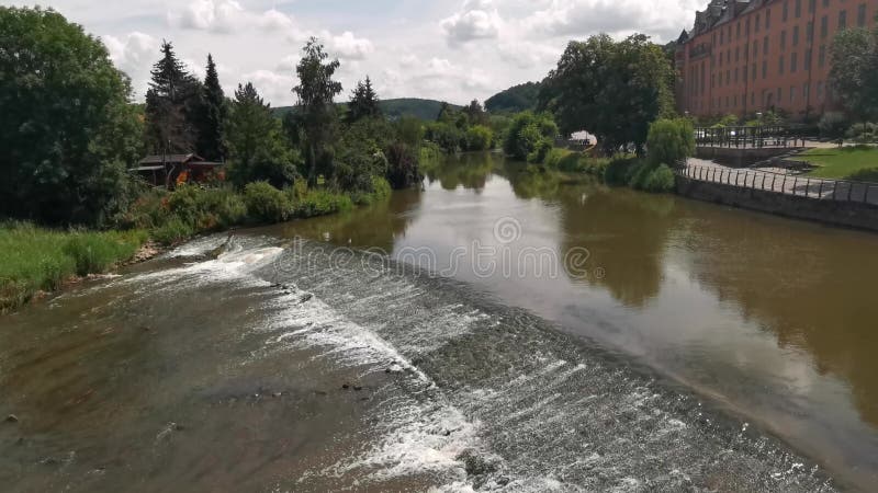 River Weser Flows Gently Over a Small Weir, Reflecting the Clear Blue Sky Stock Footage - Video ...