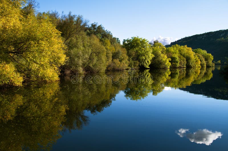 Riverbank Tree Line and River Reflection Stock Photo - Image of vila ...