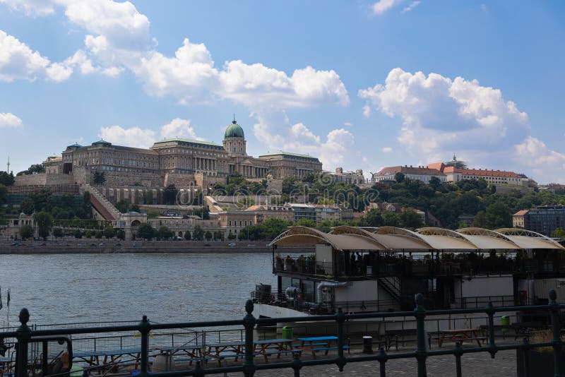 A Riverfront View of Budapest: Cityscape with Boats and Bridge Stock ...