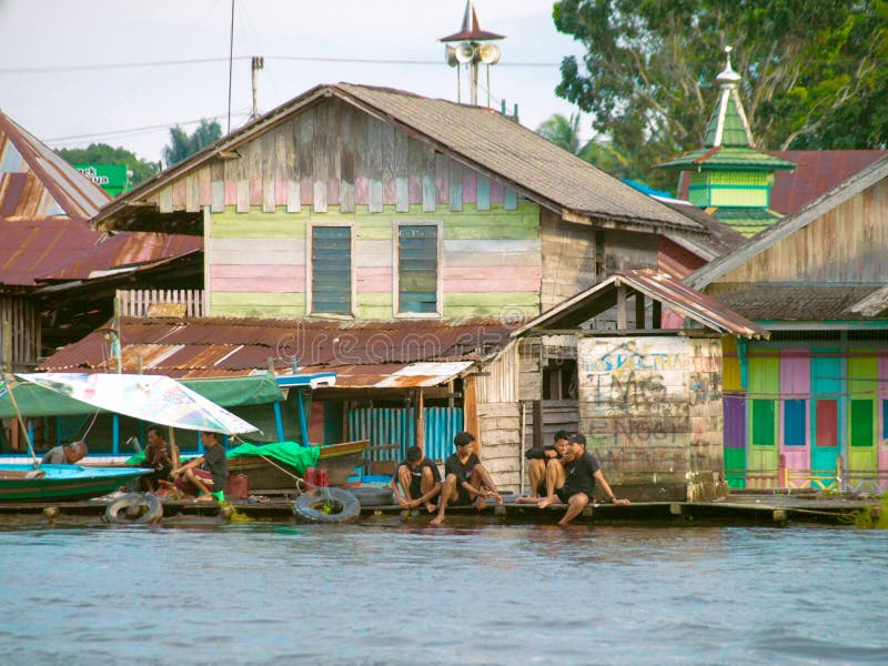 Riverfront Village: Colorful Houses and Relaxed Men Editorial Stock ...