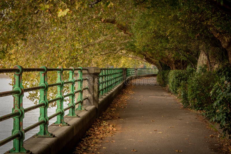 A Riverside Footpath through a Park in Autumn with Vignette Stock Image ...