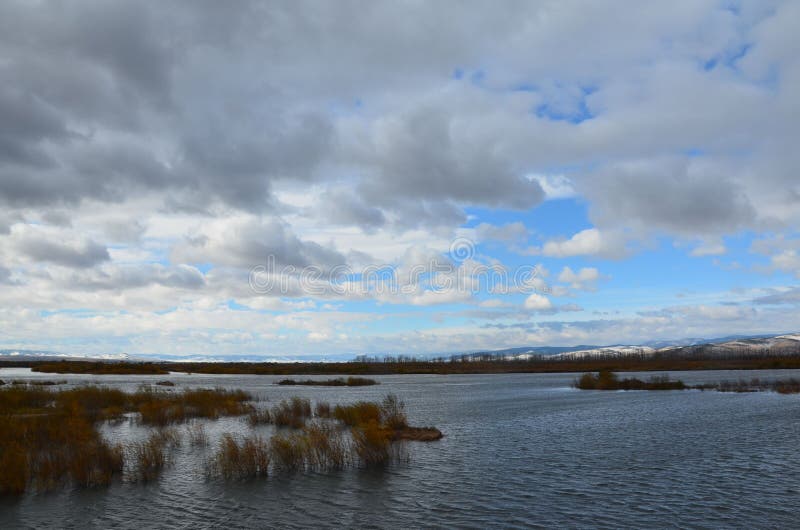 A riverside with mountains stock photo. Image of outside - 128762292