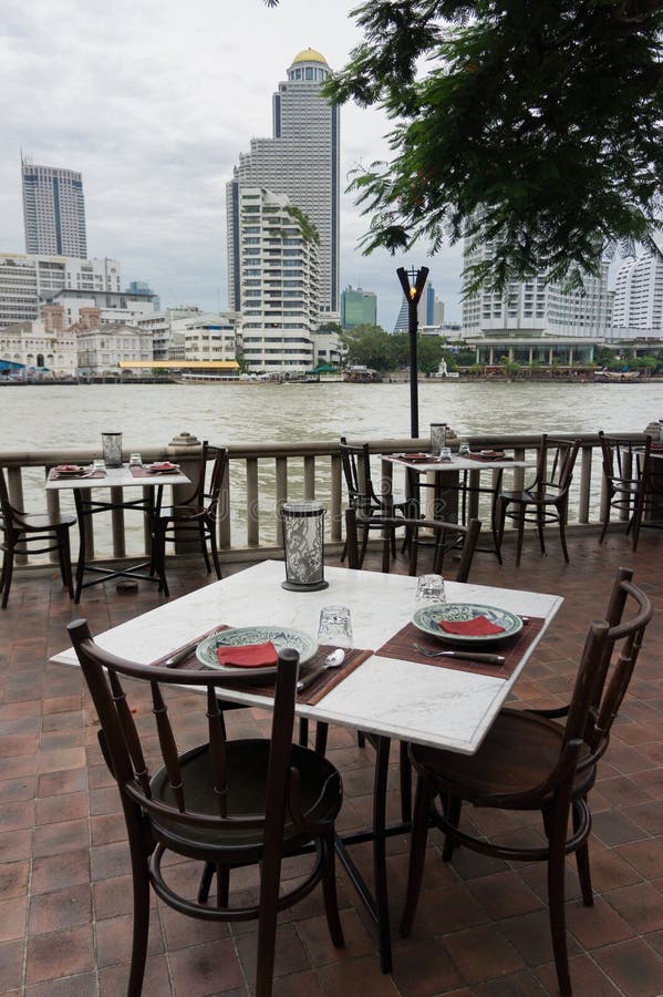 Riverside Restaurant Table and Seats during Sunset Stock Photo - Image ...