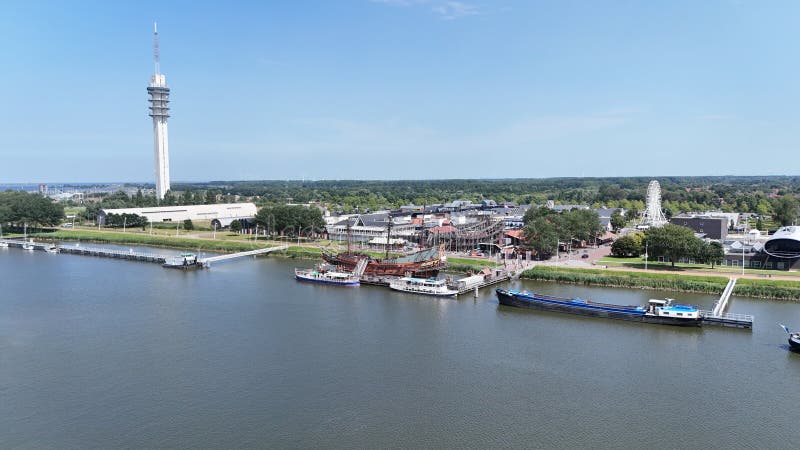 Riverside Town with Observation Tower and Boats Stock Photo - Image of ...
