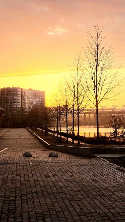 Scenic Riverside Walkway at Sunset in Urban Setting Stock Photo - Image ...