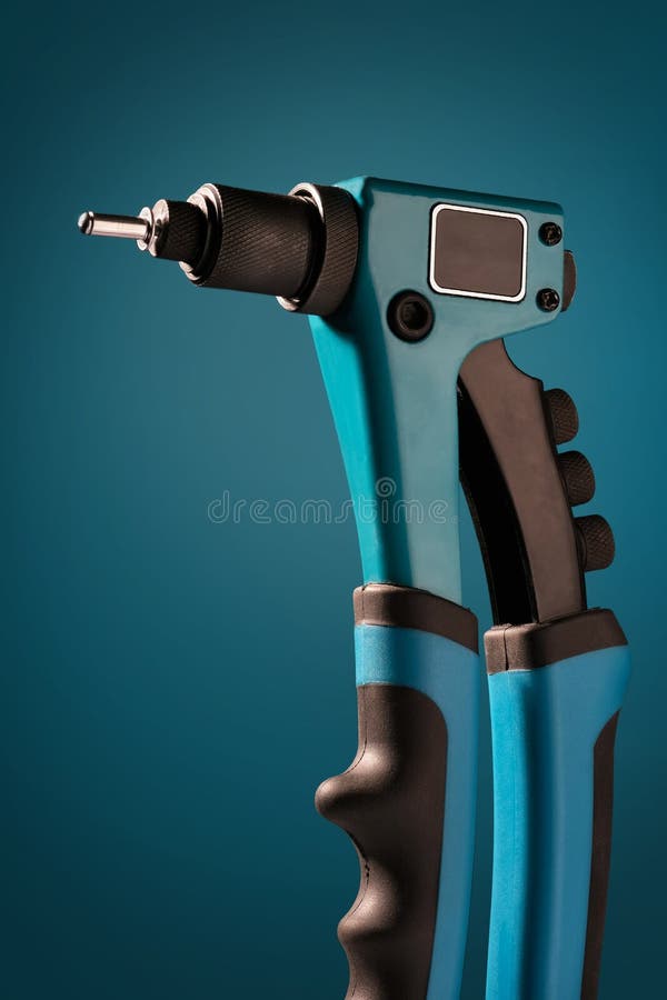 Rivet Gun and Rivet on Blue Background. Space for Text. Stock Photo ...