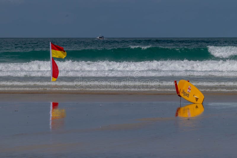 RNLI Lifeguard Paddleboard and Red and Yellow Warning Flag Stock Image ...