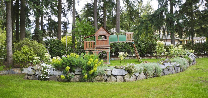 House Spring Backyard with Rock Wall and Kids Playground. Stock Photo ...
