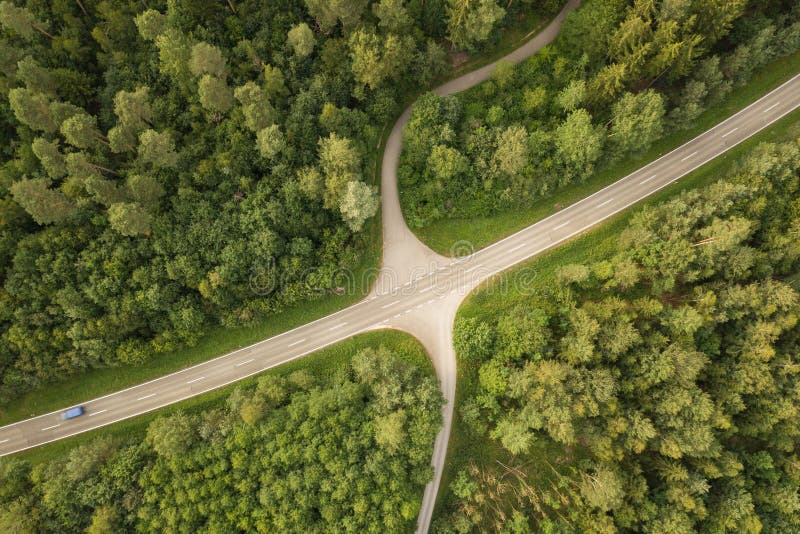 Road with Car and Intersection through Forest from Above Stock Photo ...