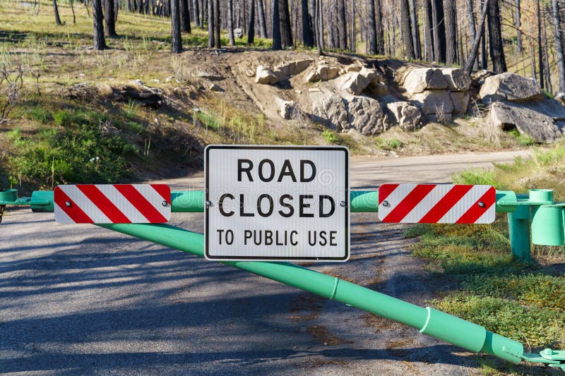 A Road Closed Sign in Front of a Gate in the Forest Stock Image - Image ...