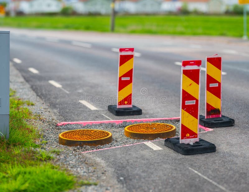 Road Construction Area with Traffic Warning Signs and Manholes.. Stock ...