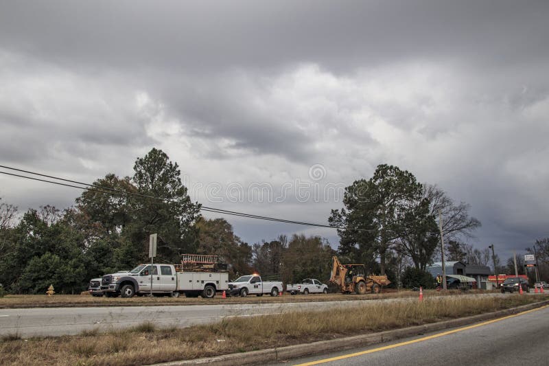 Road Construction Crew Work with Storm Clouds Editorial Photography ...